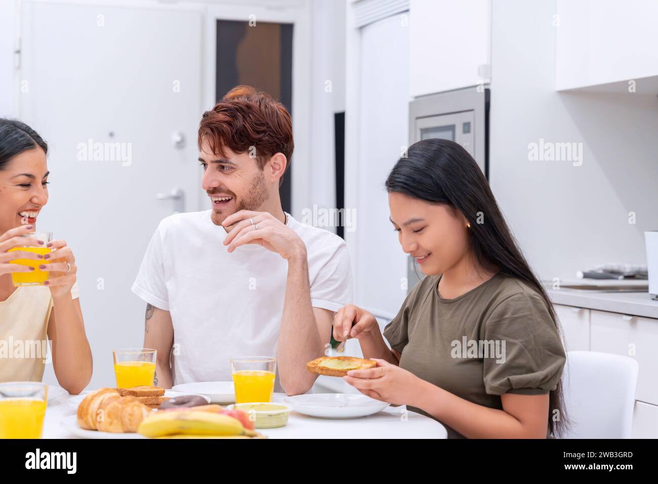 Young women eating croissants hi-res stock photography and images - Alamy