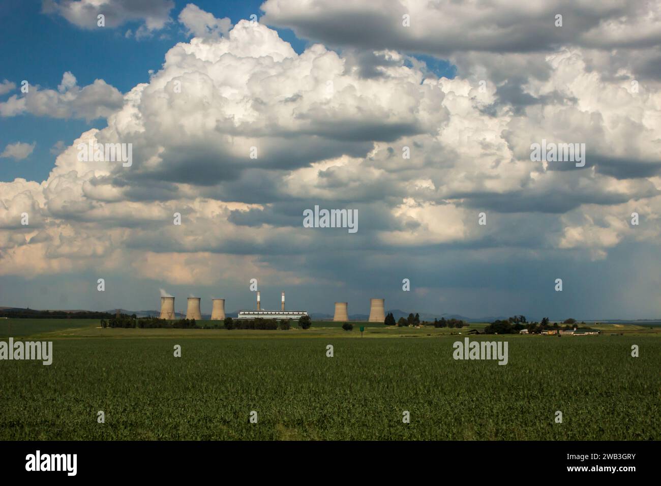 Cumulus clouds gathering overhead of a coal burning Power Station among ...