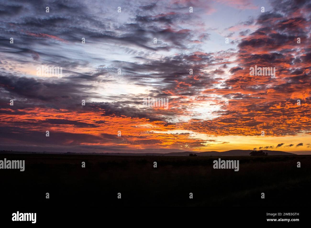 Dramatic sky at dawn, over the highveld grasslands of South Africa ...