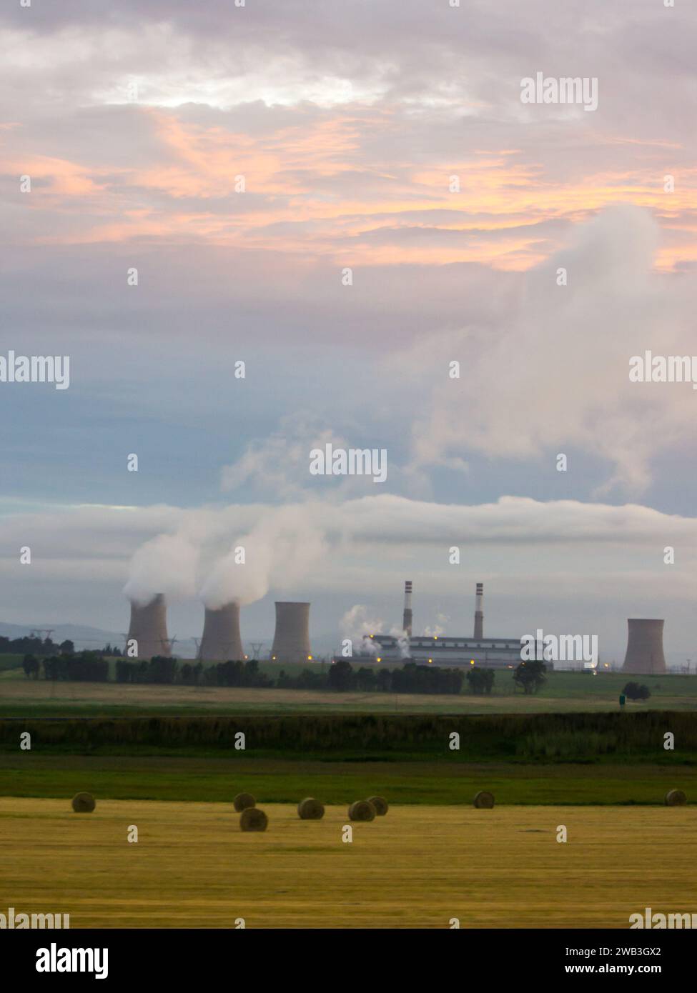 A coalfired power station with a field filled with hay bales in the ...