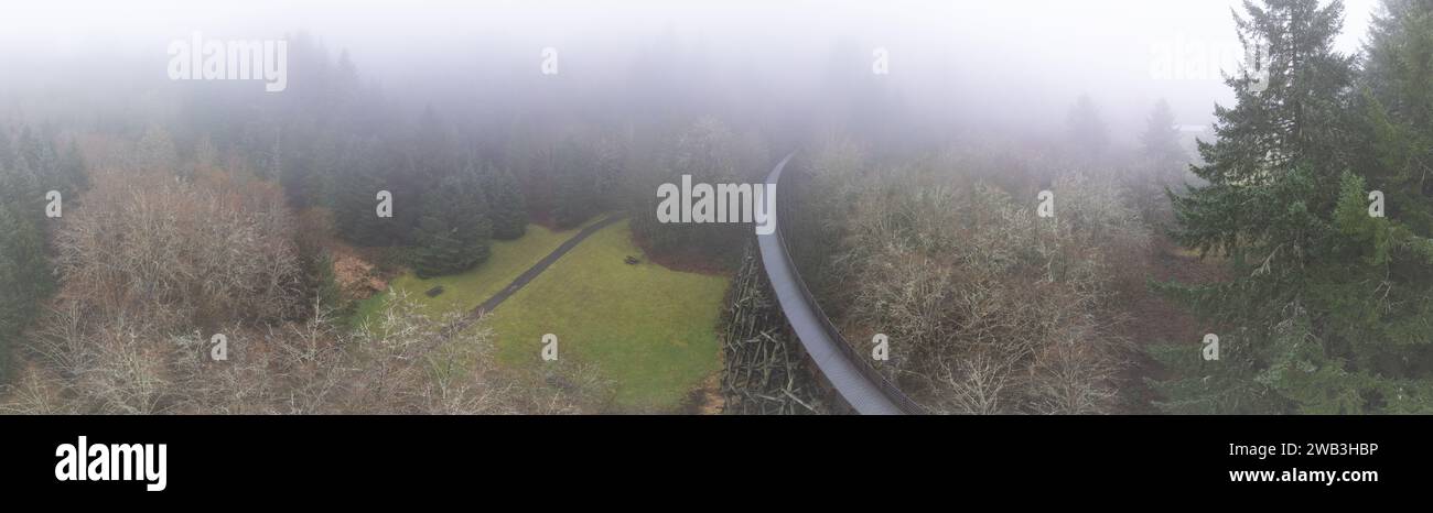 Low rain clouds drift across the Banks Vernonia trail, an old railroad ...