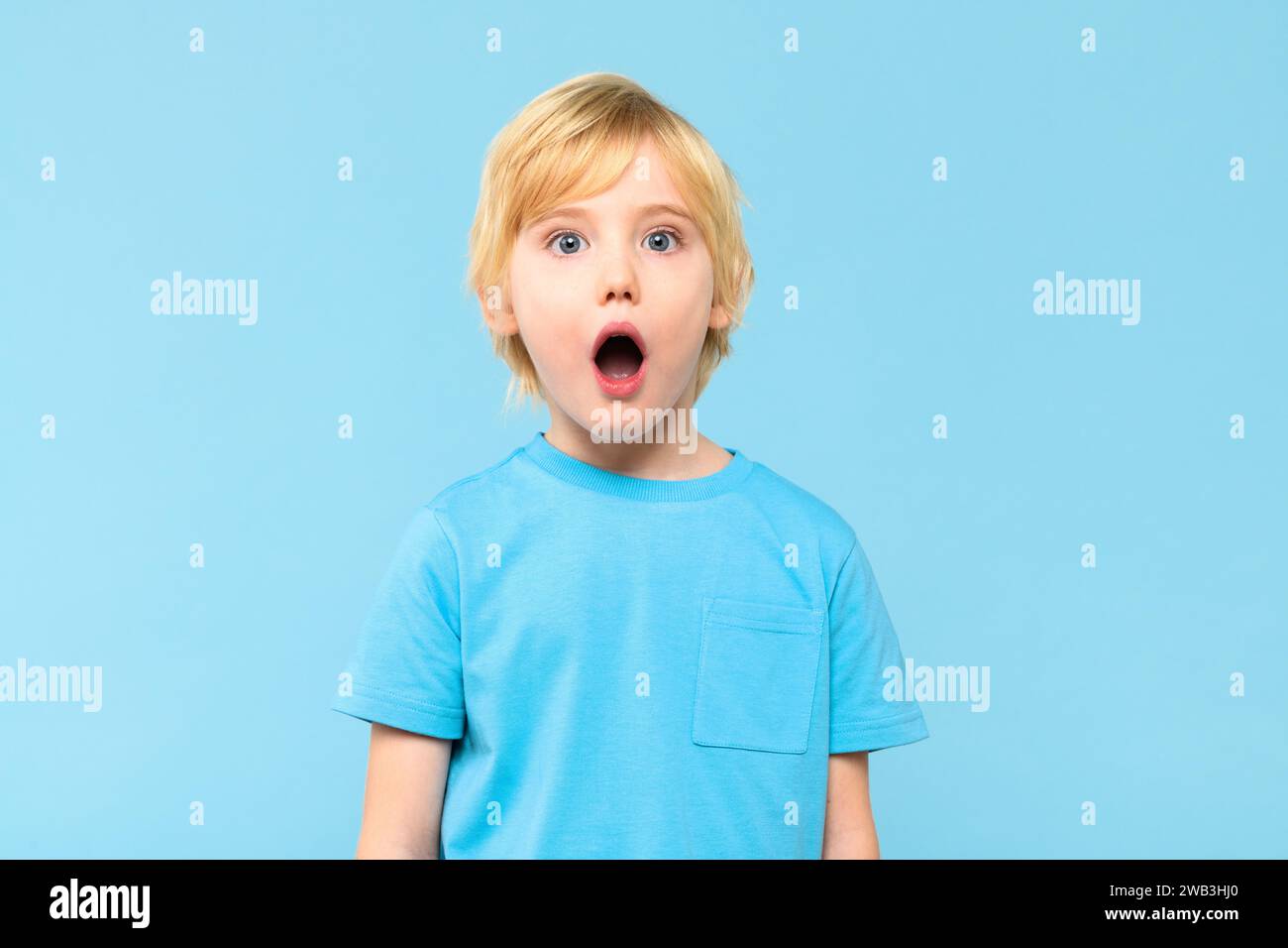 Wow! Portrait of a shocked cute little boy with blond hair on pastel ...