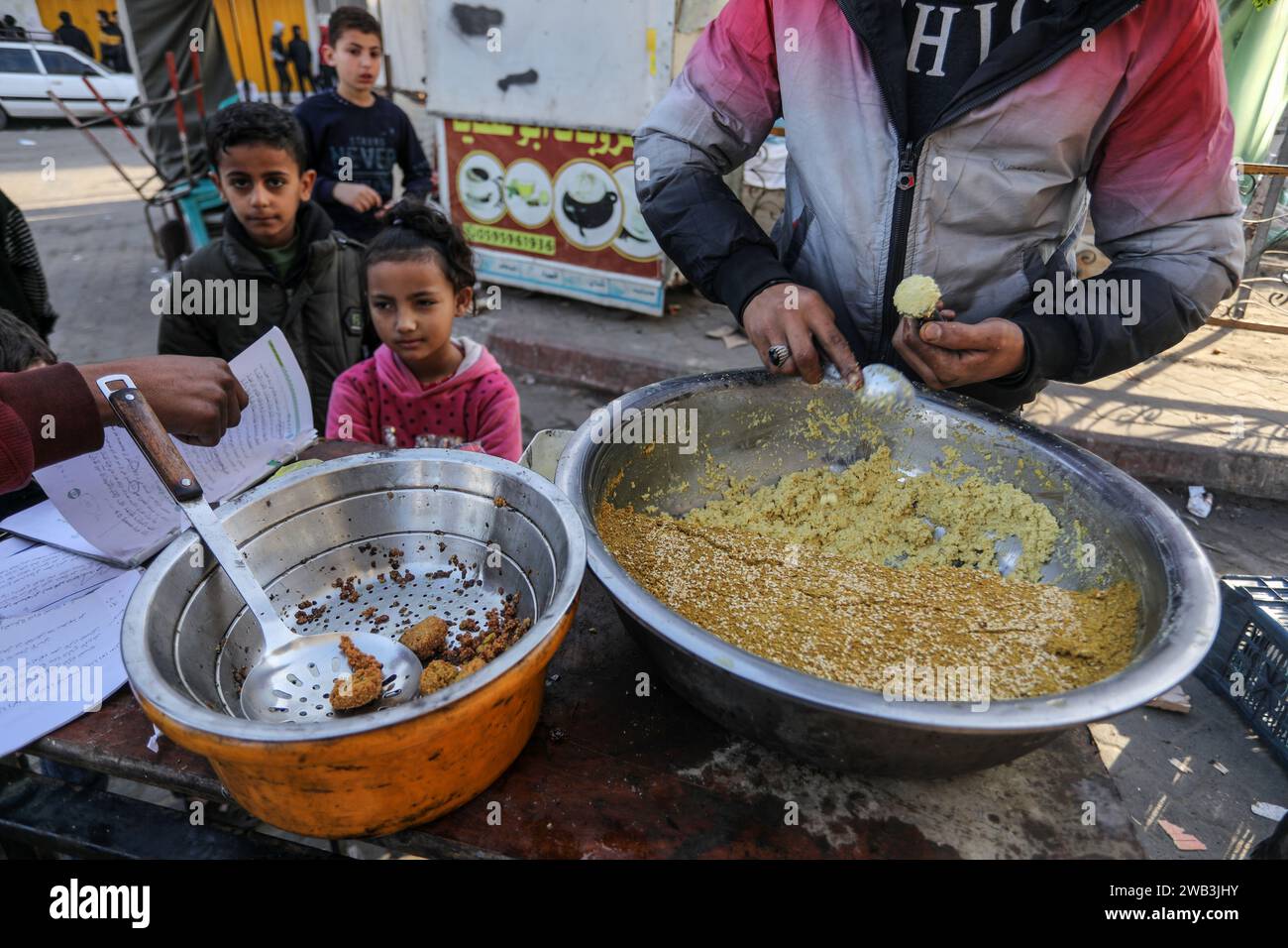 Rafah, Palestinian Territories. 08th Jan, 2024. Children look on as a ...