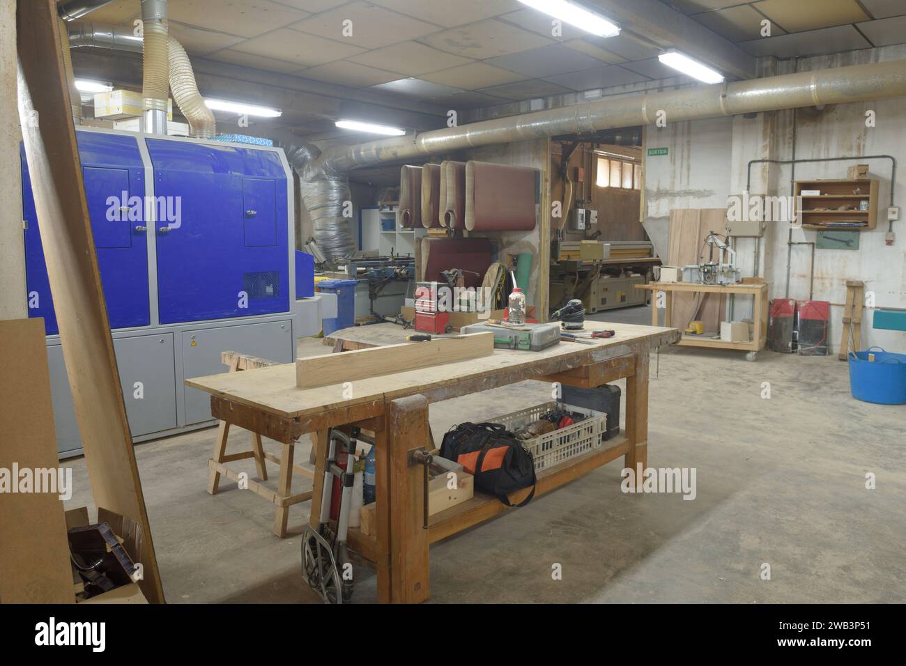 interior view of a carpentry industry with machinery and a workbench ...