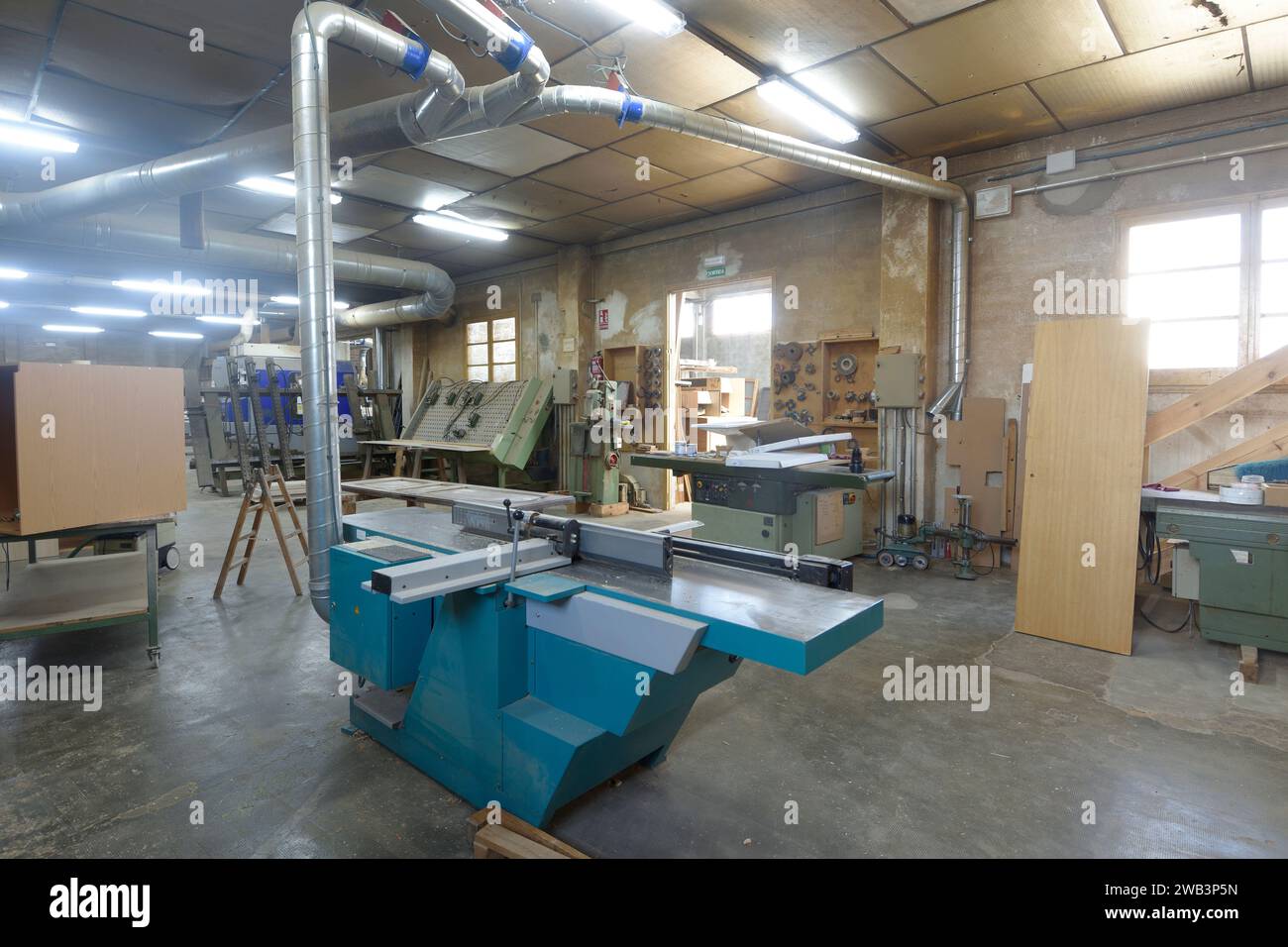 view of a carpentry with a machine and its dust extraction Stock Photo ...