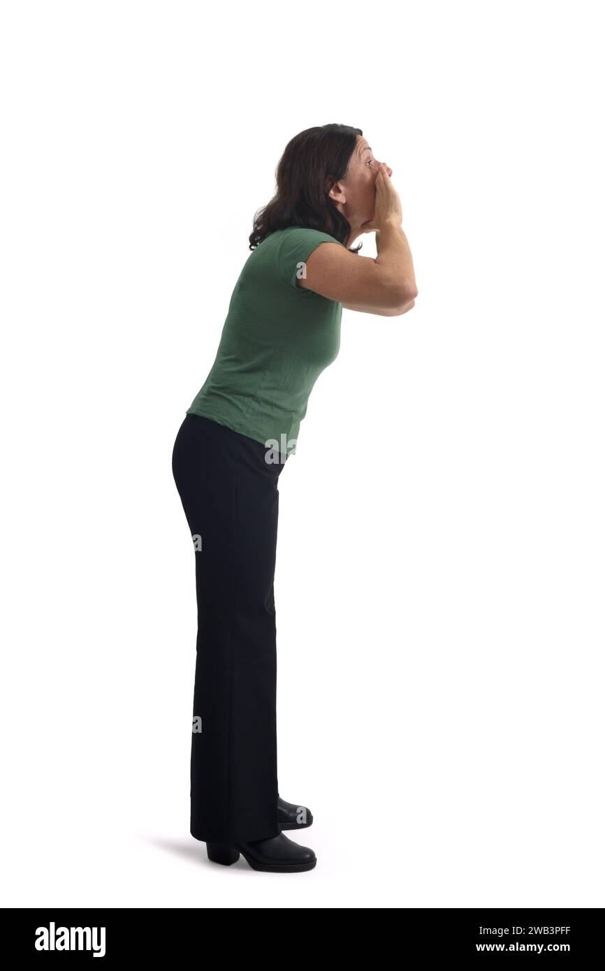 side view of a standing woman who is screaming on white background ...