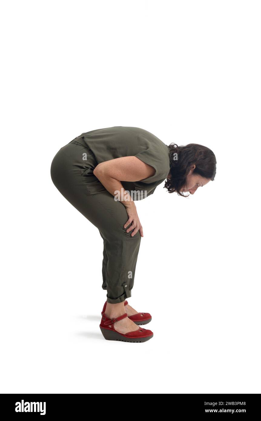 side view of a woman standing looking at the floor searching for ...