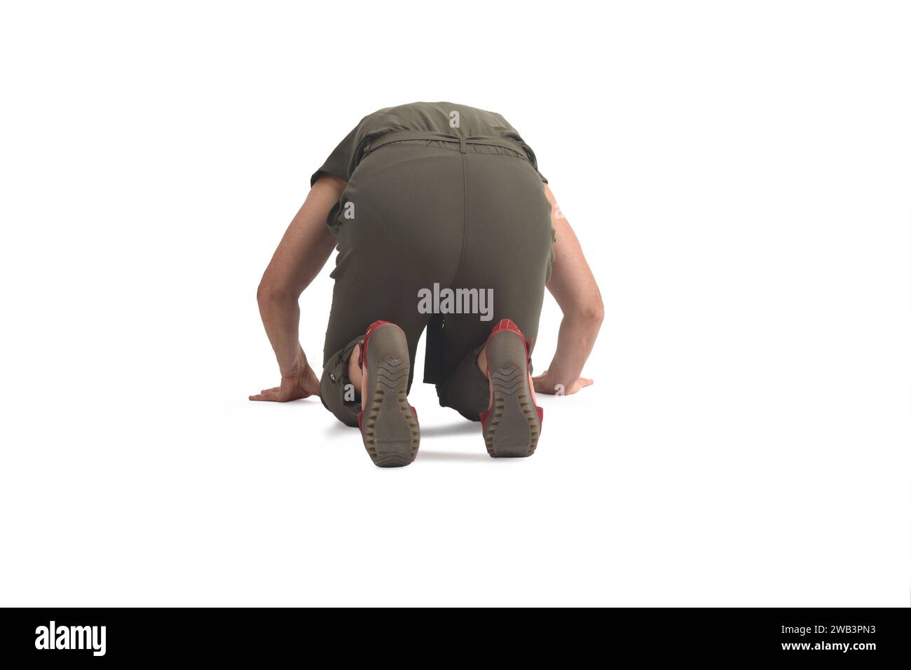 rear view of a woman on her knees searching or staring at something on ...