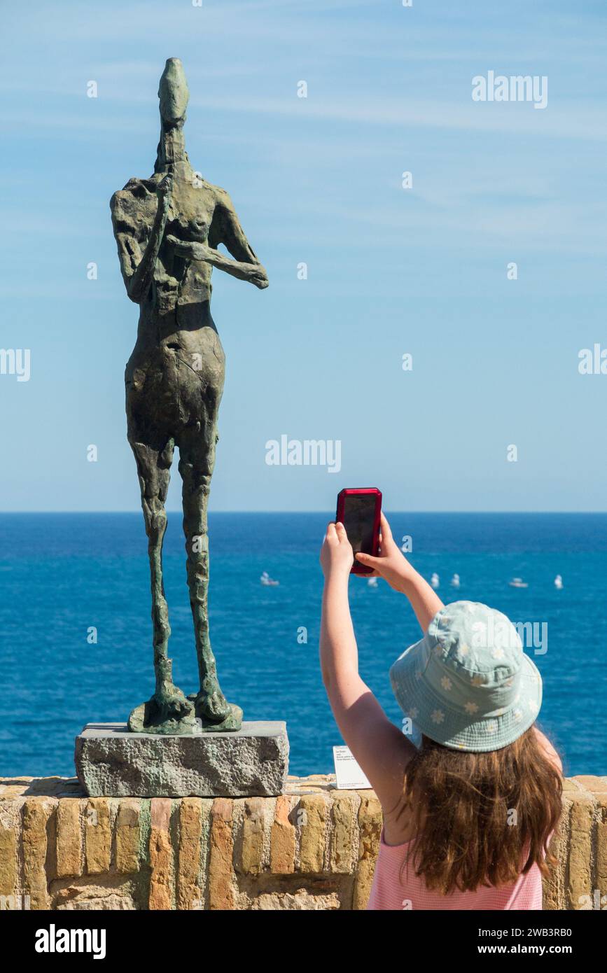 Girl / child photographing 'Le Grain' statue sculpture by Germaine ...