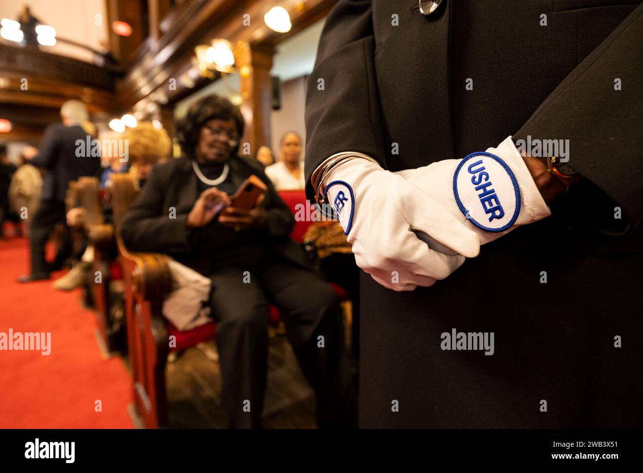 An usher waits to seat guests as they wait for President Joe Biden to ...