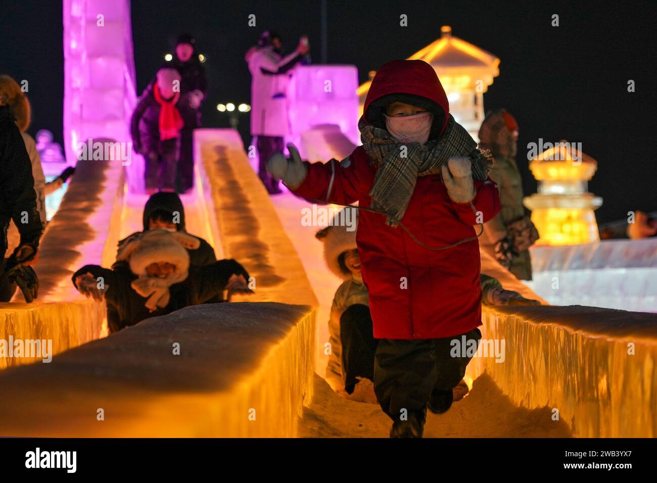Visitors having fun on an ice slide as they visit the annual Harbin Ice ...