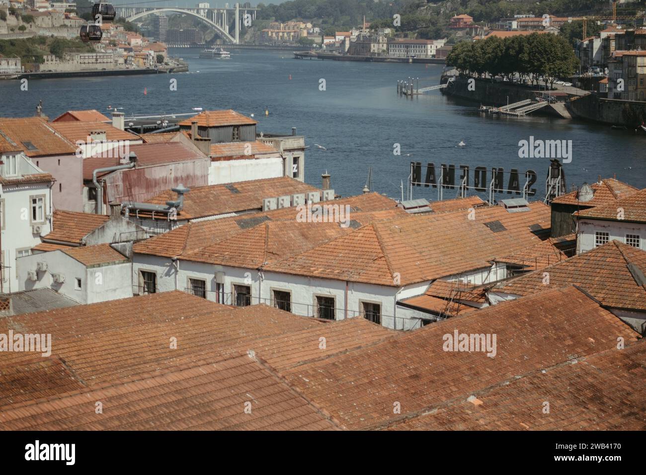 Aerial view of a modern cityscape with colorful rooftops and homes on a ...