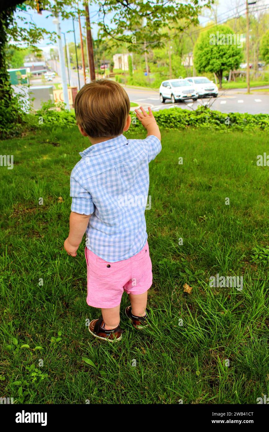 Boy waving goodbye hi-res stock photography and images - Alamy