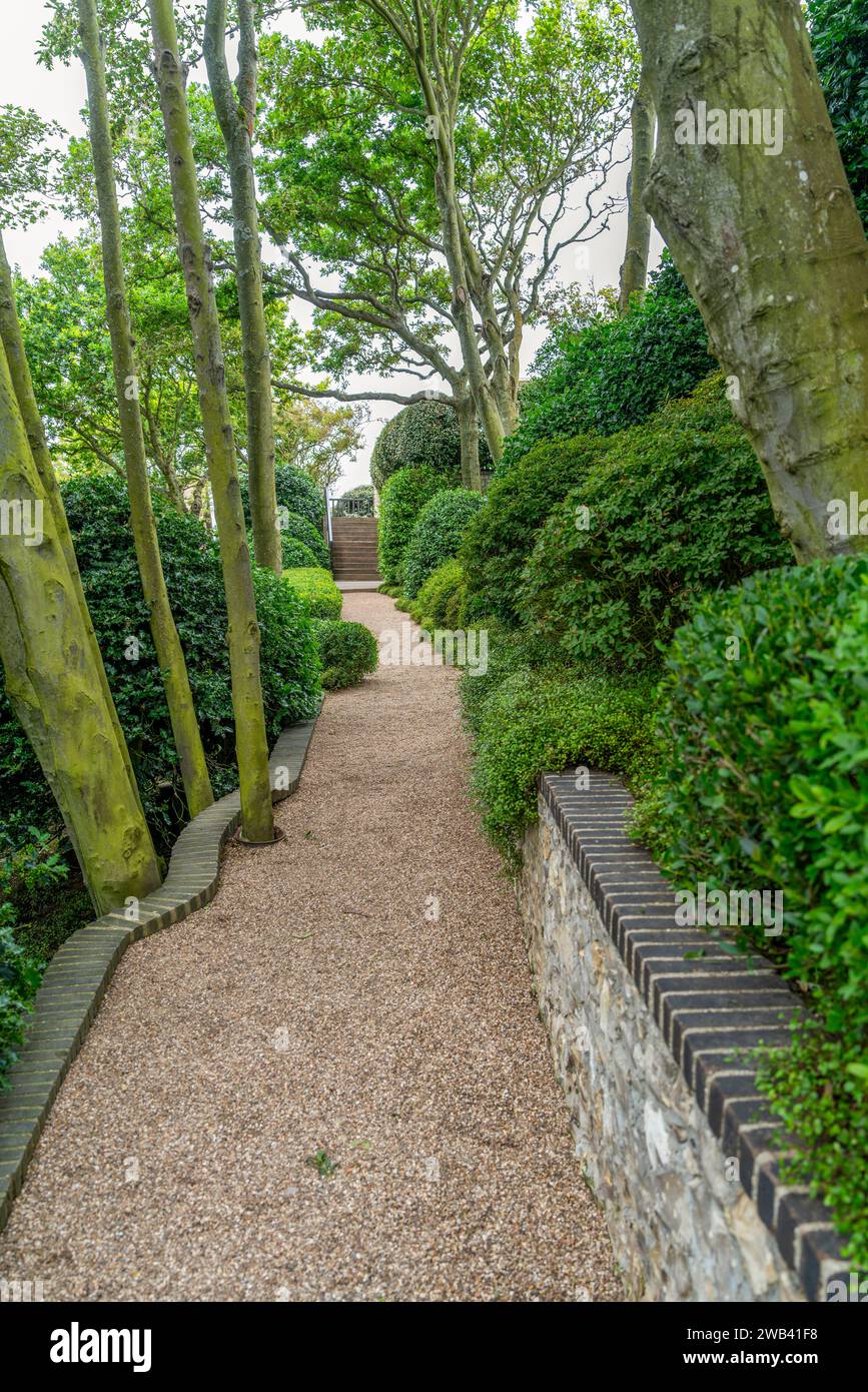 Idyllic park scenery with green trees, bushes and hedges including a ...