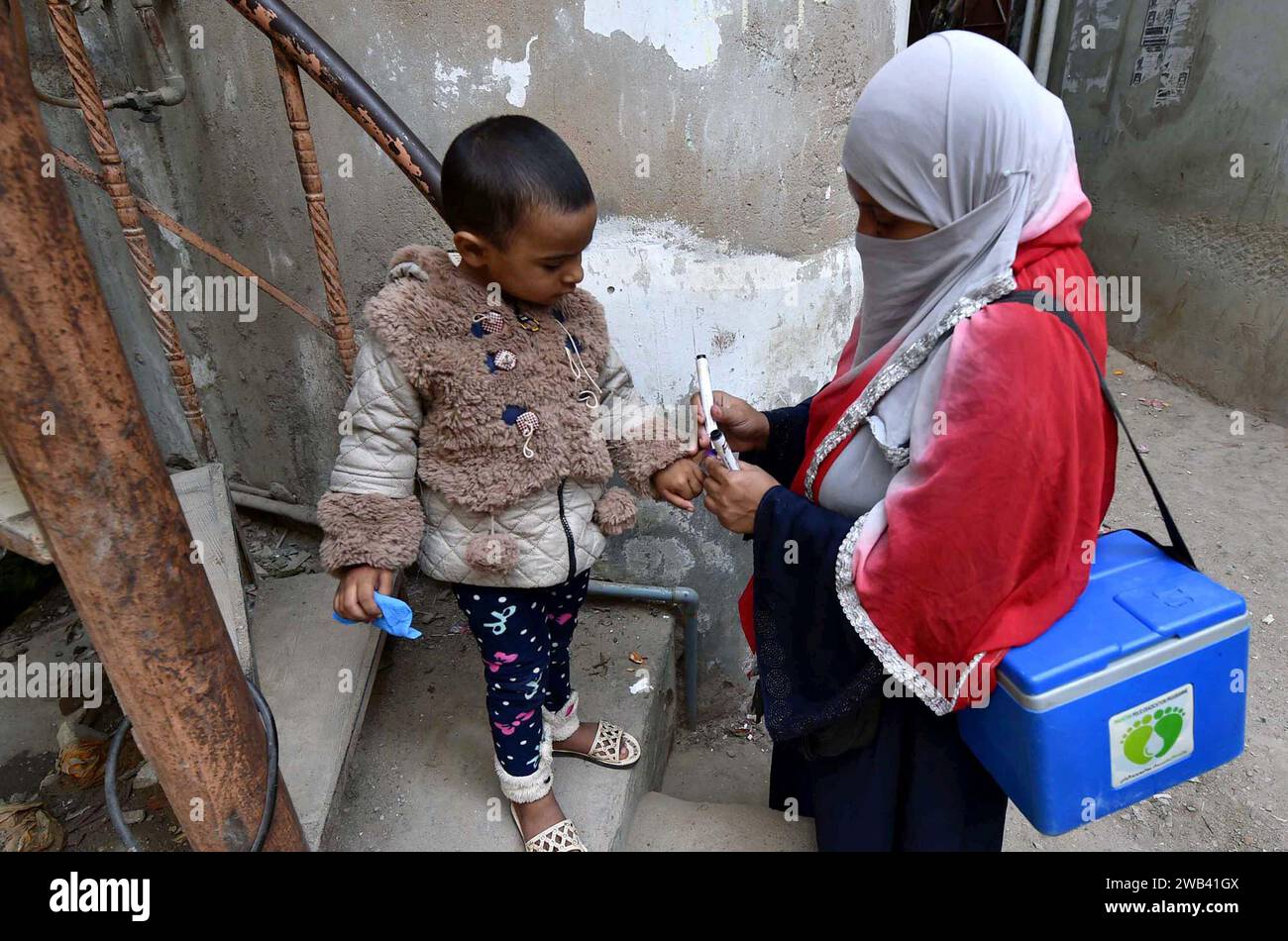 Health worker administrates polio-vaccine drops to a child during anti ...