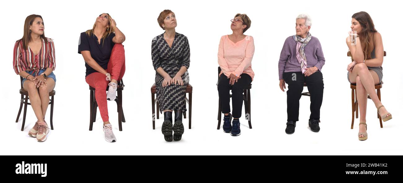 group of women sitting looking everywhere on white background Stock ...