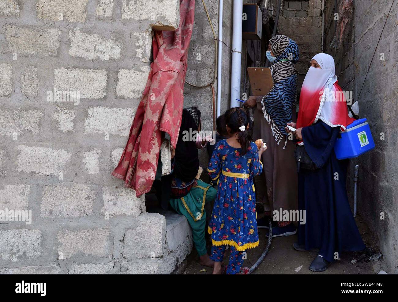 Health worker administrates polio-vaccine drops to a child during anti ...