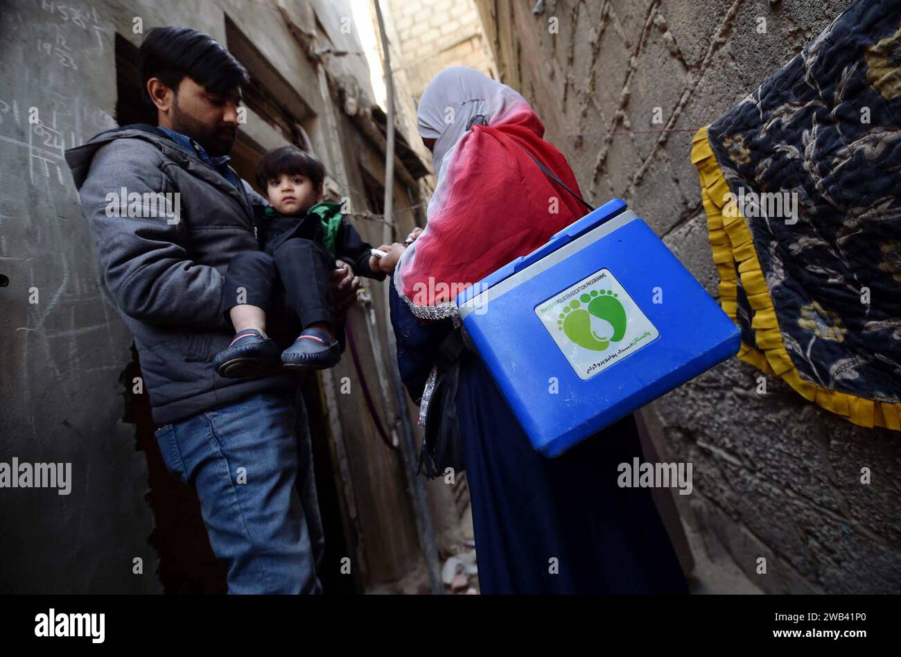 Health worker administrates polio-vaccine drops to a child during anti ...