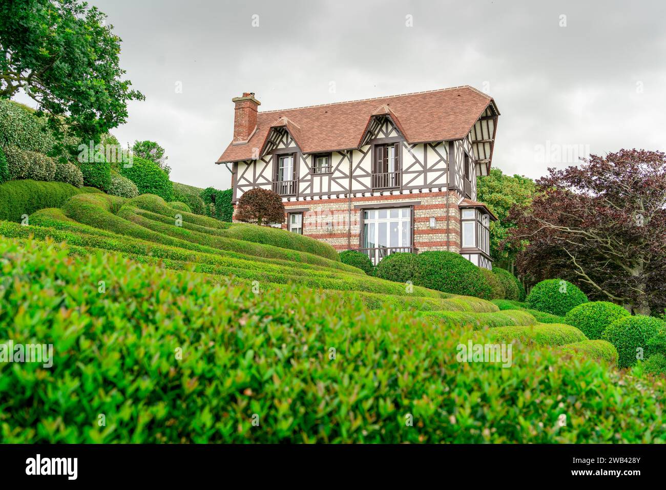 Half-timbered historic house surrounded by a idyllic garden scenery ...