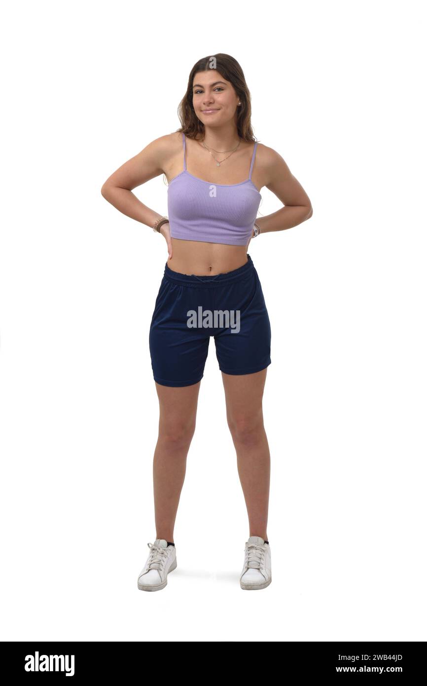 front view of a young girl standing with arm akimbo and looking at ...