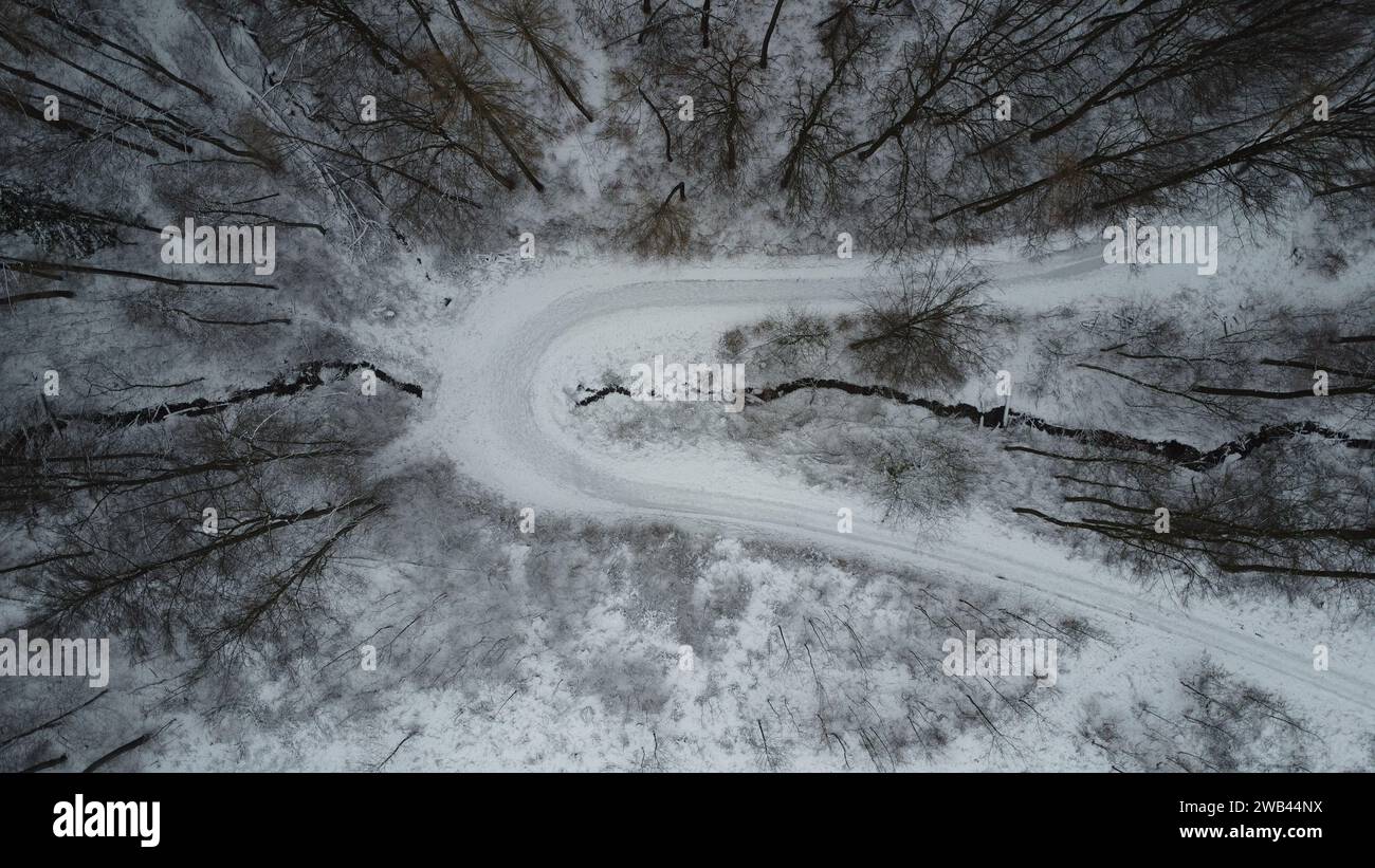 Bird's eye view of a snow-covered path through a snowy forest Stock ...