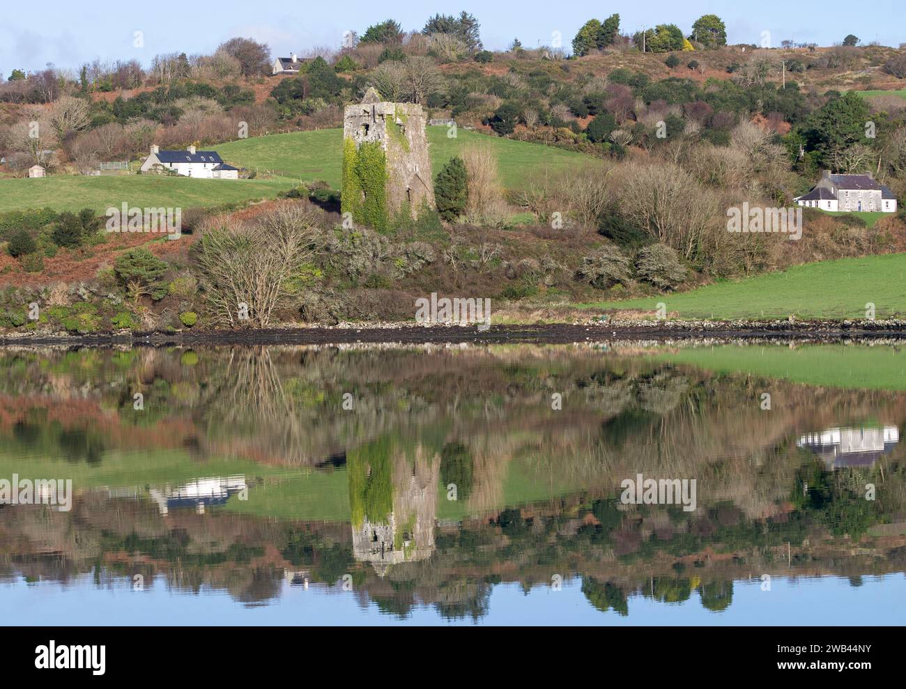 Raheen Castle reflected in the still waters of Castlehaven Harbour ...