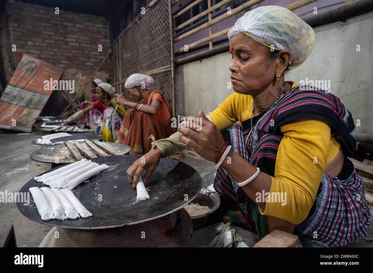 Guwahati, Assam, India. January 8, 2024. Women makes Assamese ...