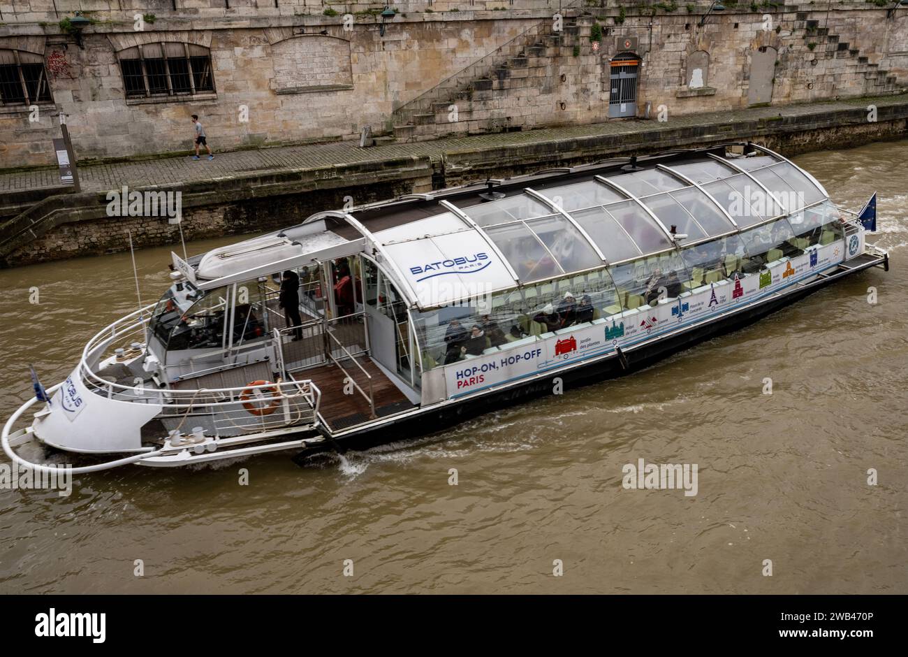 A batobus (a tourist river boat) moving along the river Seine in Paris ...