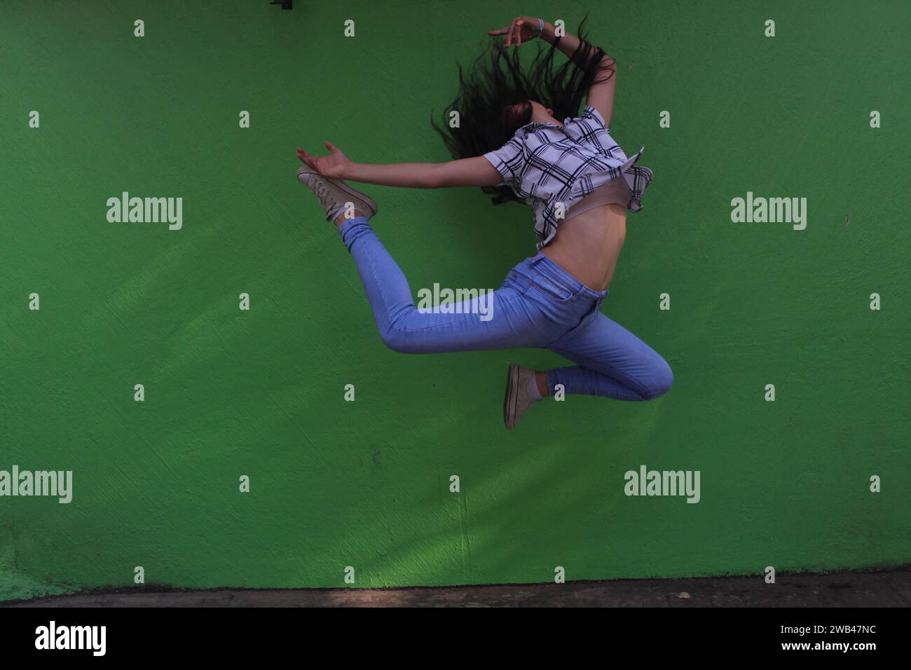 Girl jumping making gymnastics Stock Photo - Alamy