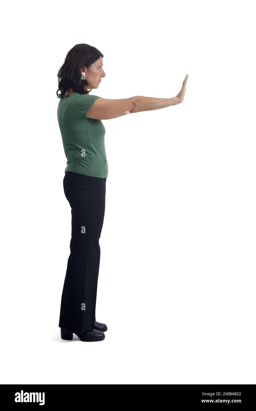 side view of a woman showing the stop sign with their hands on white ...