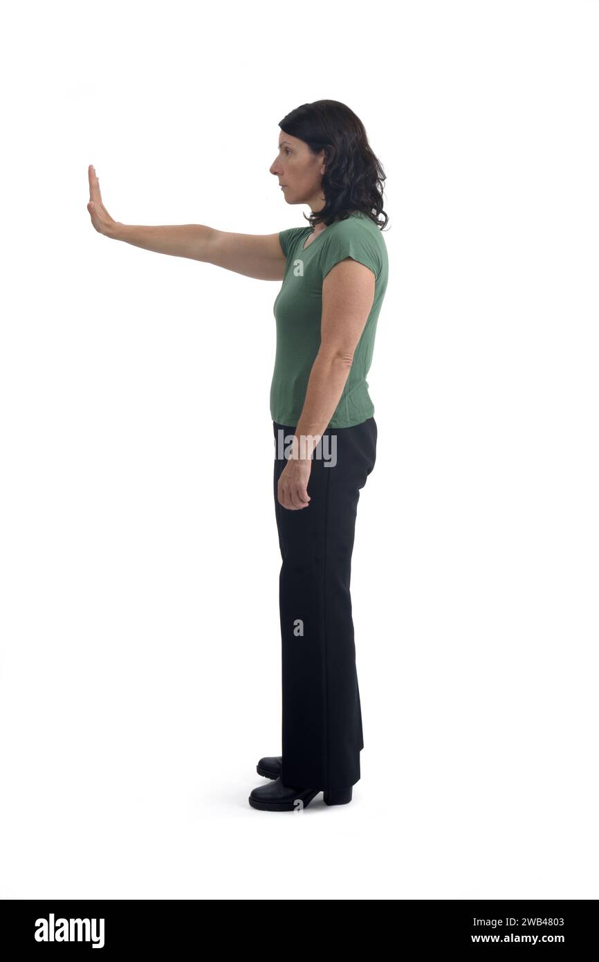 side view of a woman showing the stop sign with their hands on white ...
