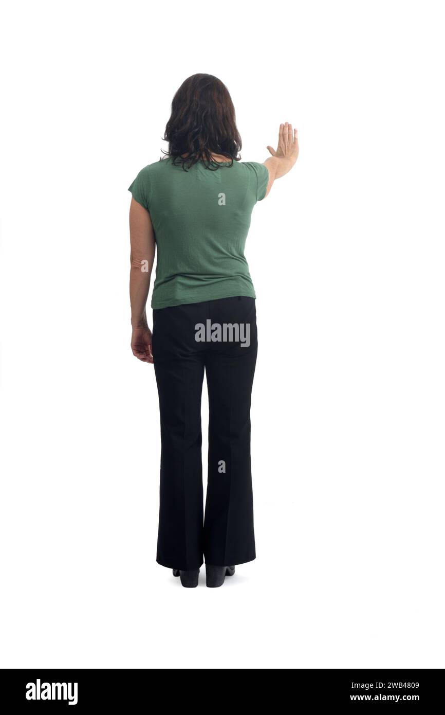 back view of a woman showing the stop sign with their hands on white ...