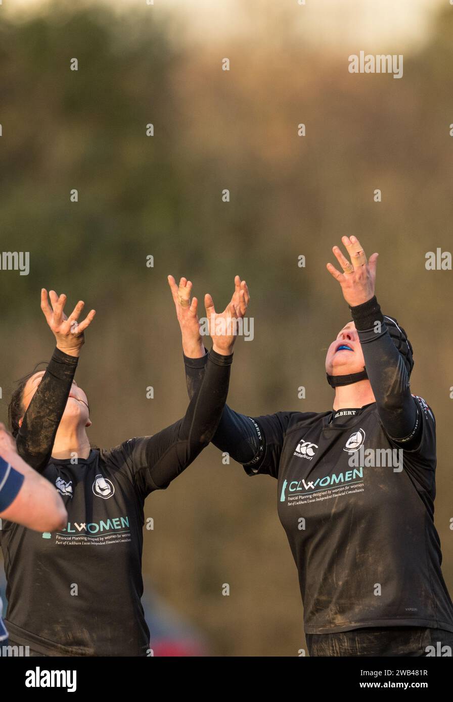Female amateur rugby union players arms out to catch the rugby football ...