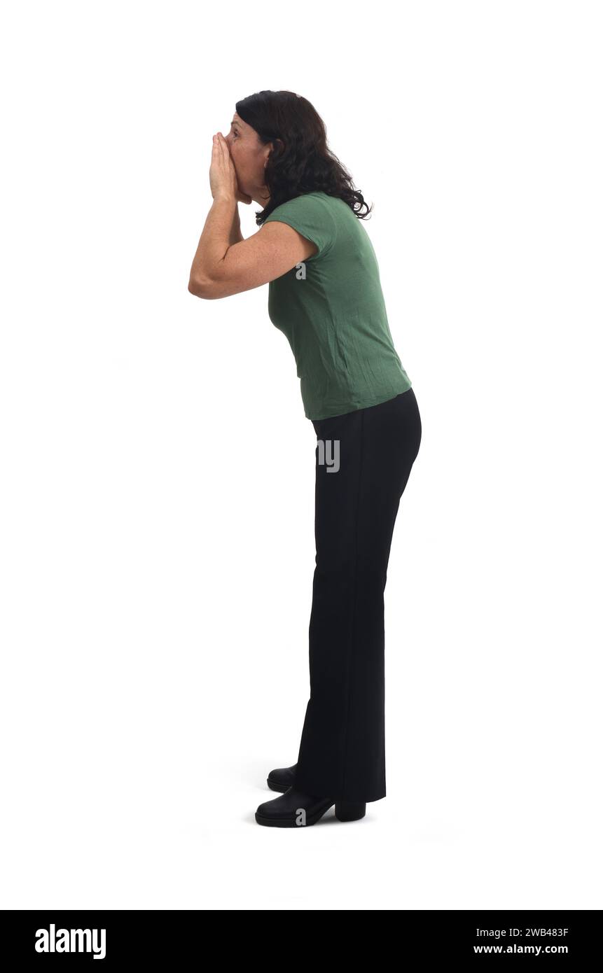 side view of a standing woman who is screaming on white background ...