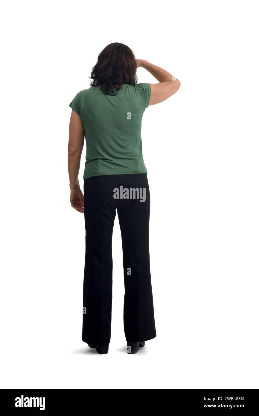 back view of a woman with her hand on her forehead looking into the ...