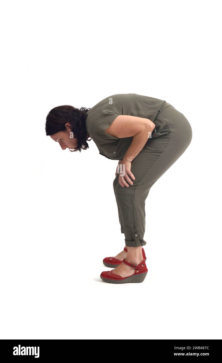 side view of a woman searching for something on the floor on white ...