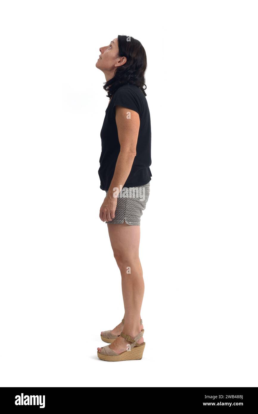side view of a woman with shorts looking up on white background Stock ...