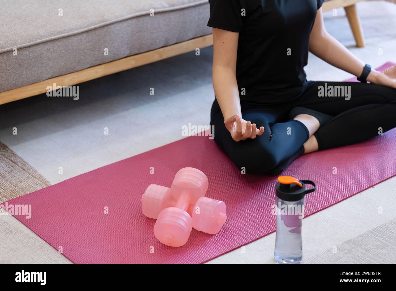 Young woman practicing lotus asana in yoga studio. Padmasana pose Stock ...