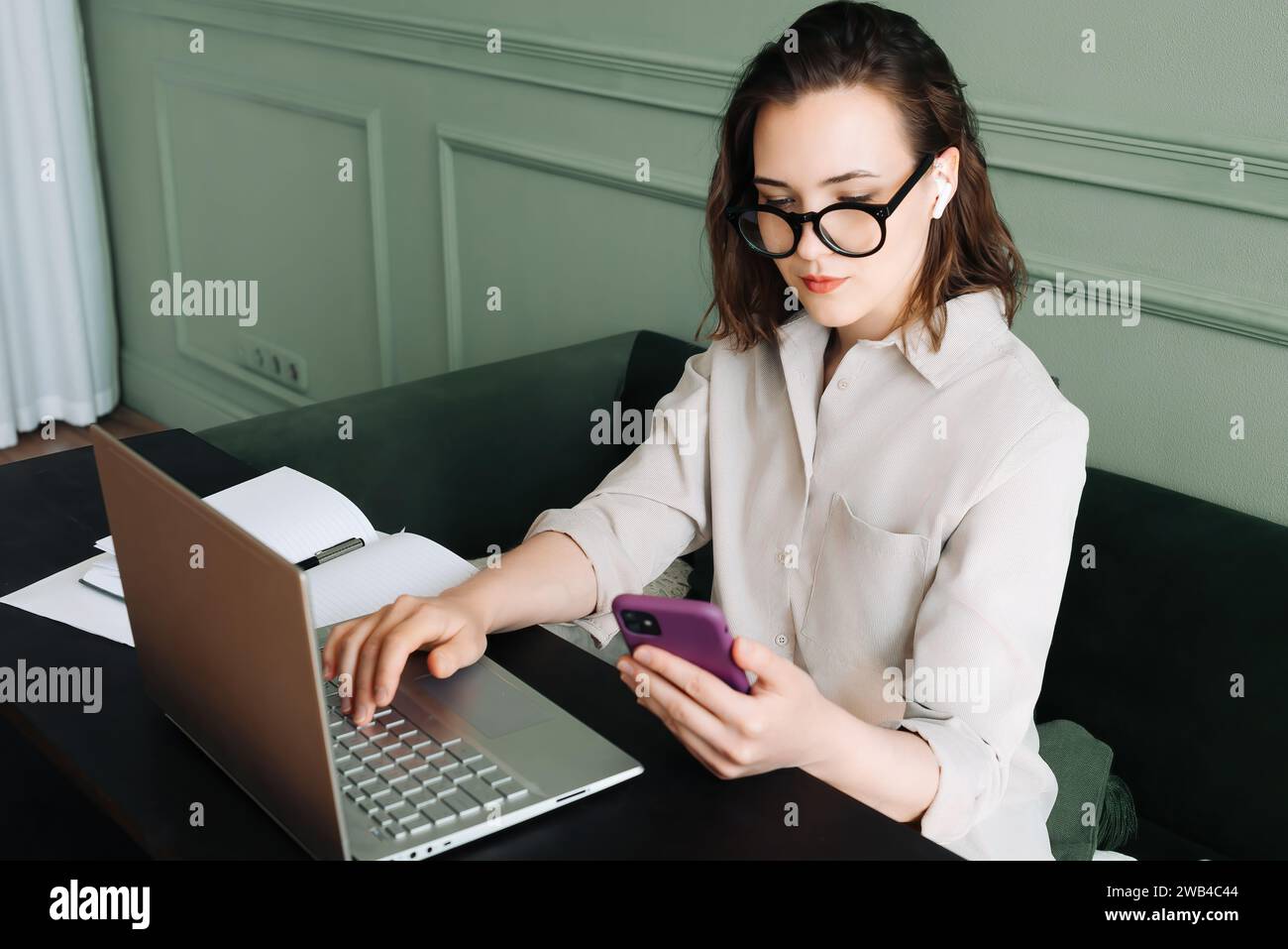 Productive Conversations. Woman Balancing Laptop and Smartphone in Video Call. Multitasking Joy ...