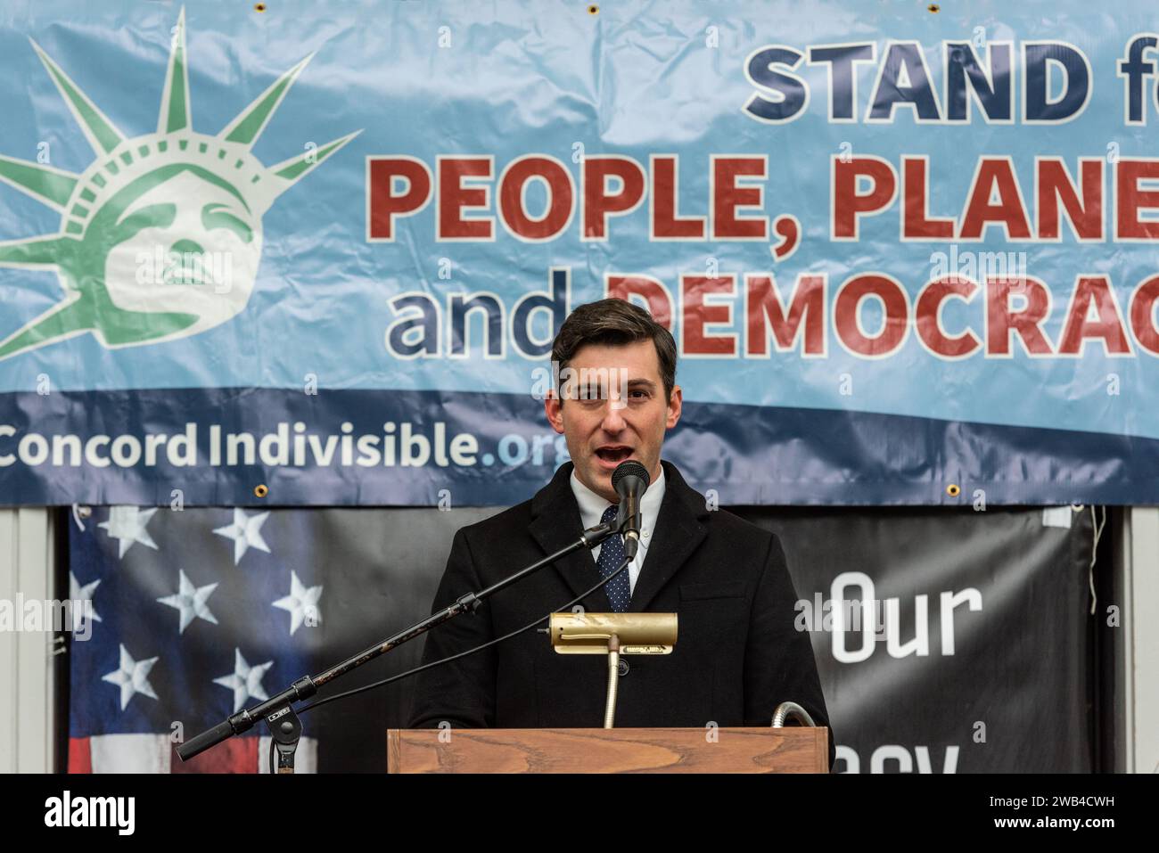 State representative Simon Cataldo speaking to a large group of people ...