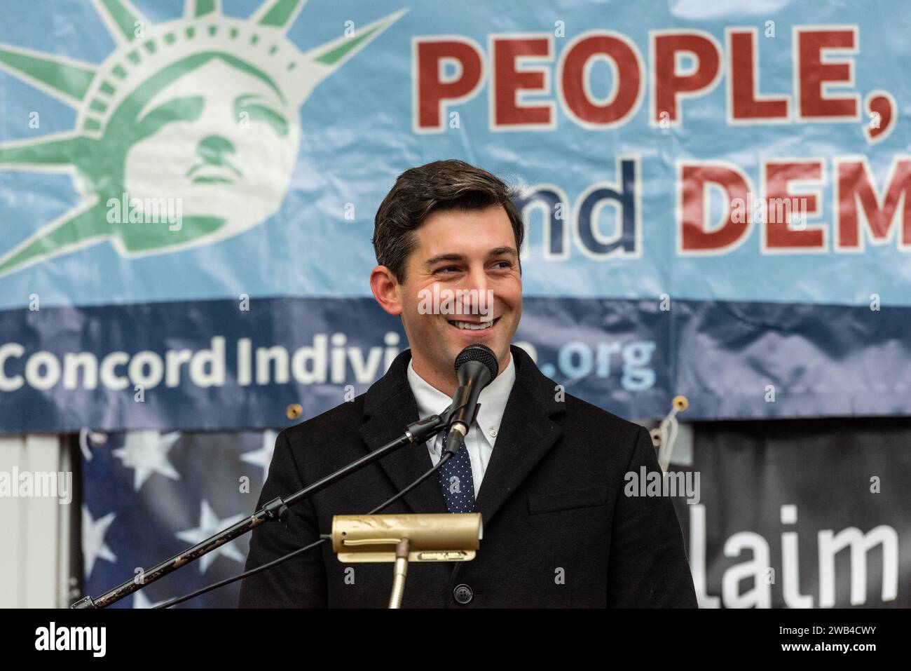 State representative Simon Cataldo speaking to a large group of people ...
