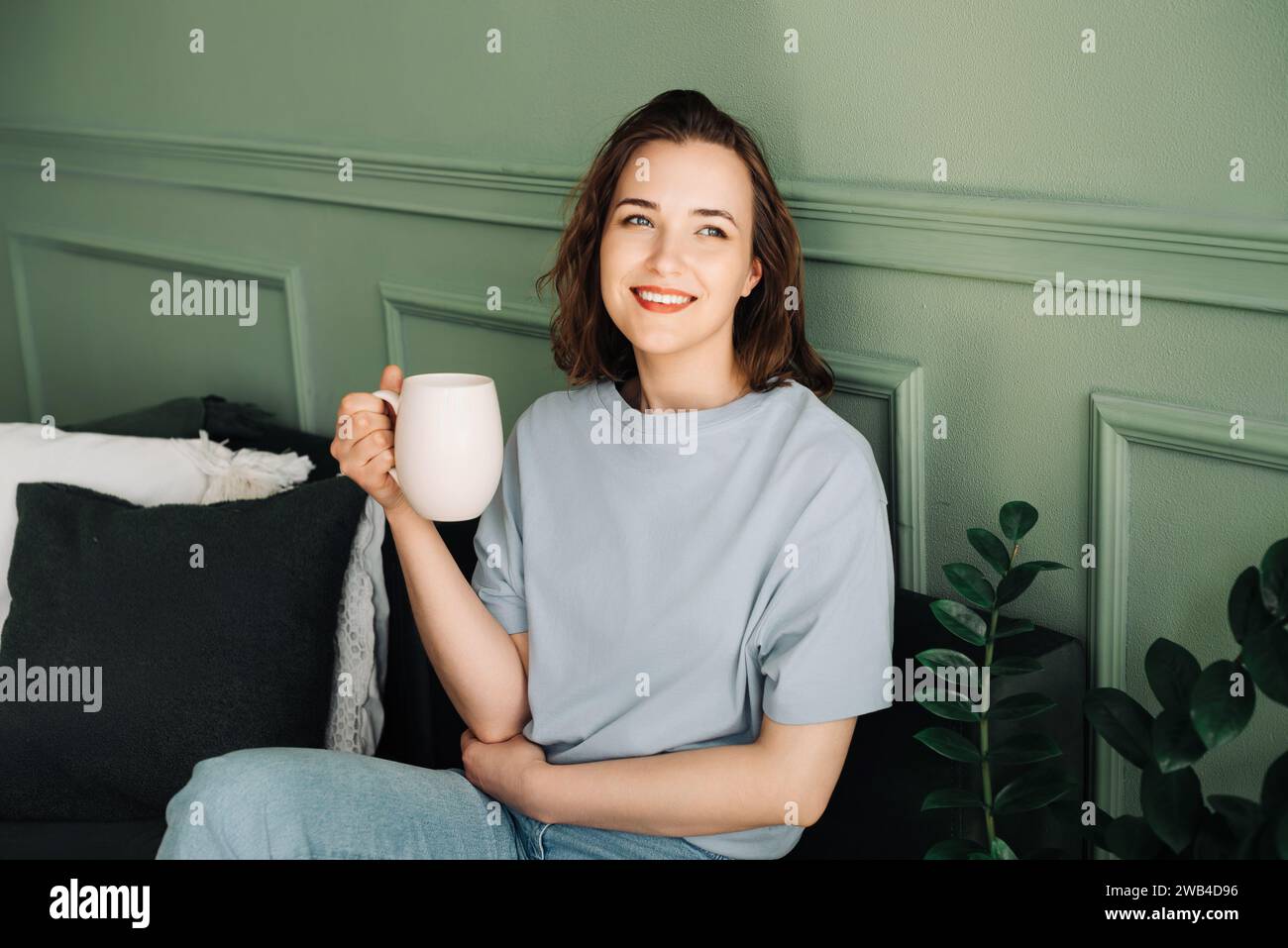 Cozy Tea Time - Cropped View of Woman Enjoying Tea on Living Room Couch ...