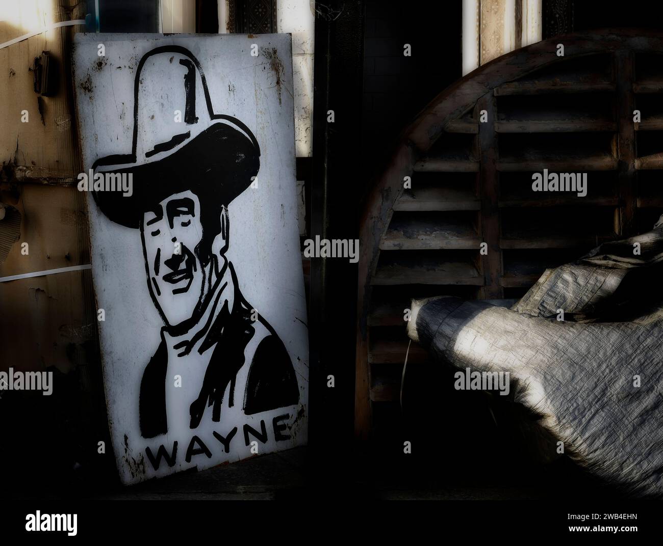 John Wayne tin sign bunkhouse finds Stock Photo - Alamy
