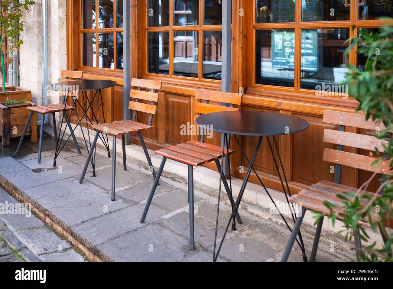 Street view of a coffee terrace with tables and chairs. Free cafe table ...