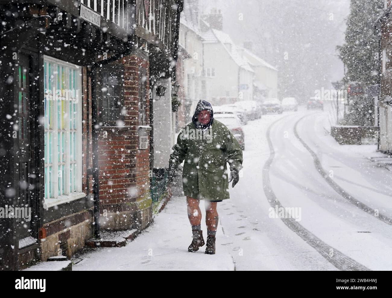 People walking through a snow flurry in Lenham, Kent. Sleet and snow ...