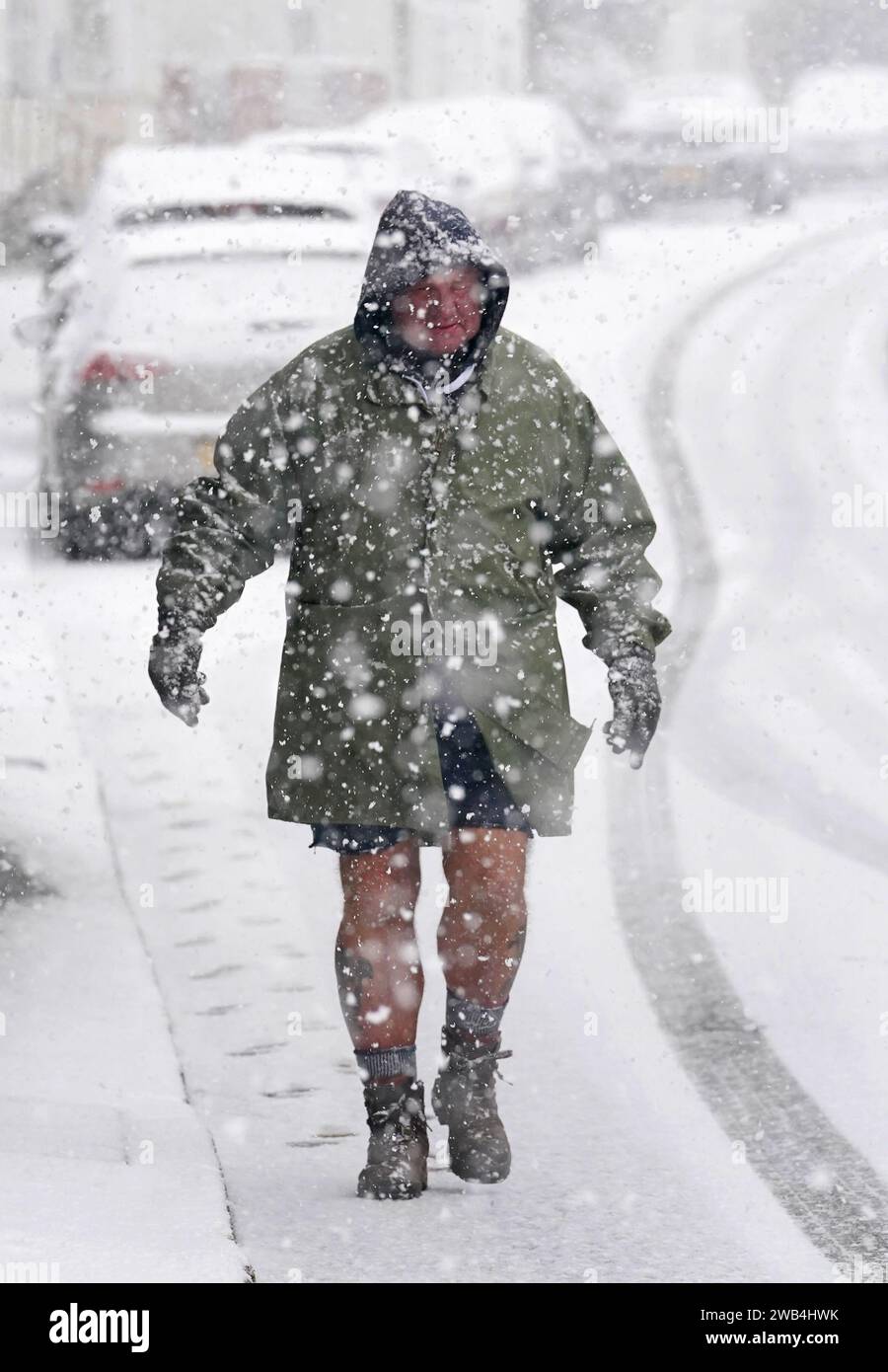 A person walking through a snow flurry in Lenham, Kent. Sleet and snow ...