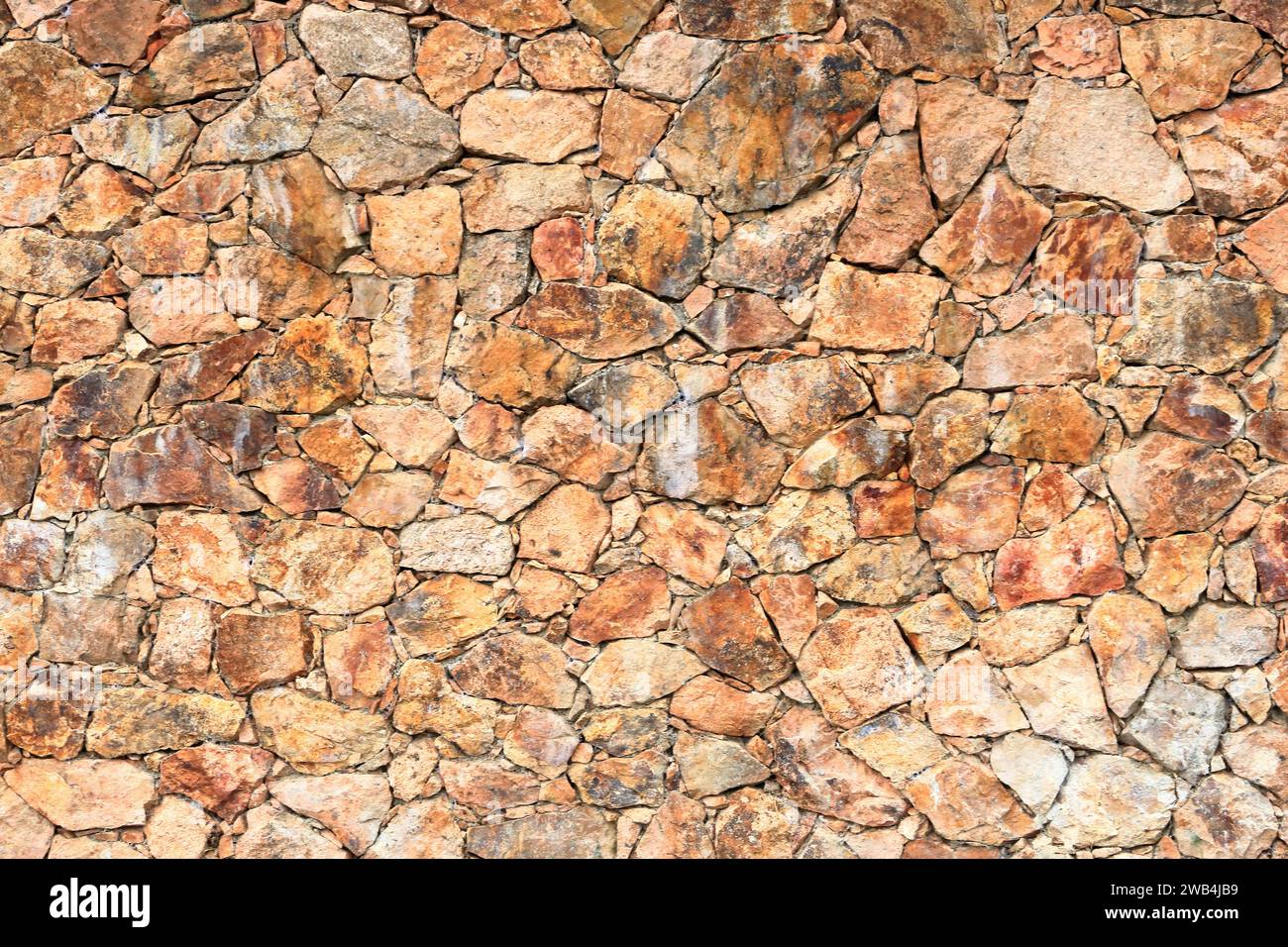 yellow beige natural stone wall of different sized stones, traditional ...