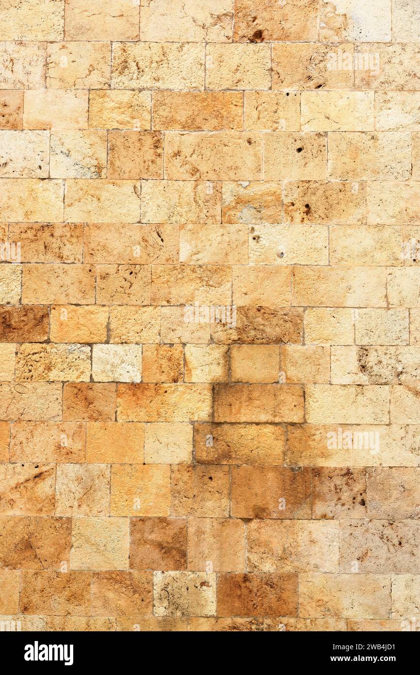 yellow beige natural stone wall of different sized stones, traditional ...