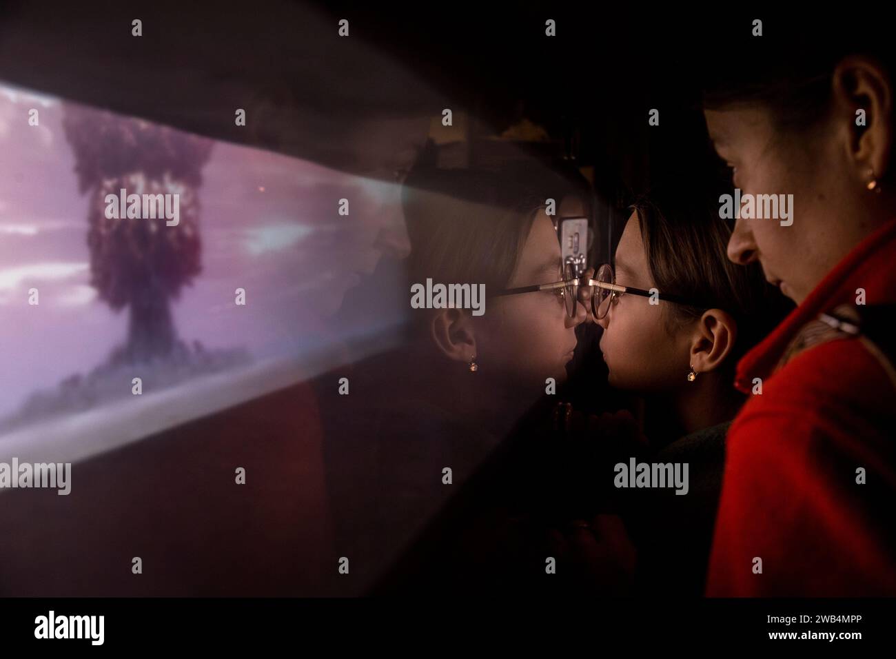 Moscow, Russia. 8th of January, 2024.Visitors watch a video of a ...