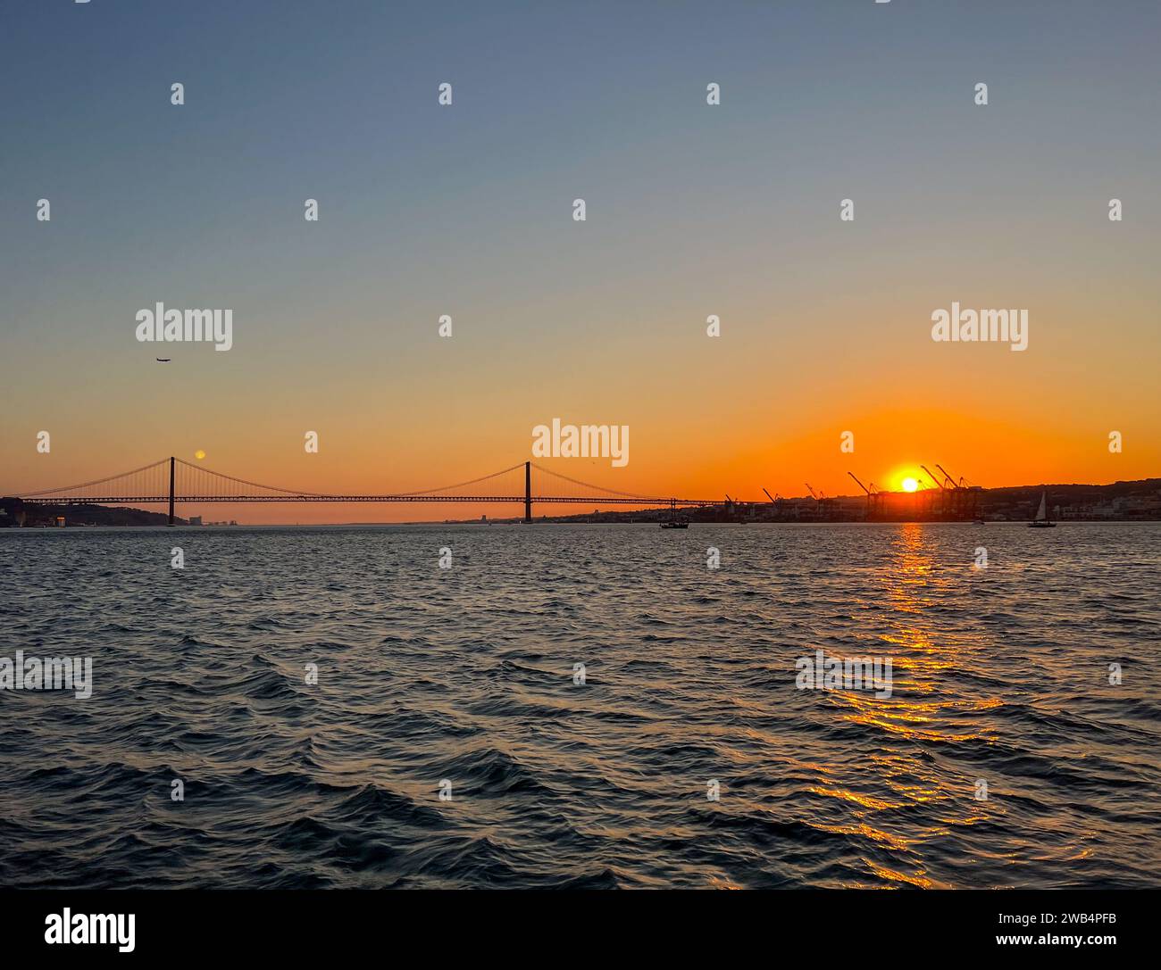 Sunset over Lisbon seen from Tagus River Stock Photo - Alamy